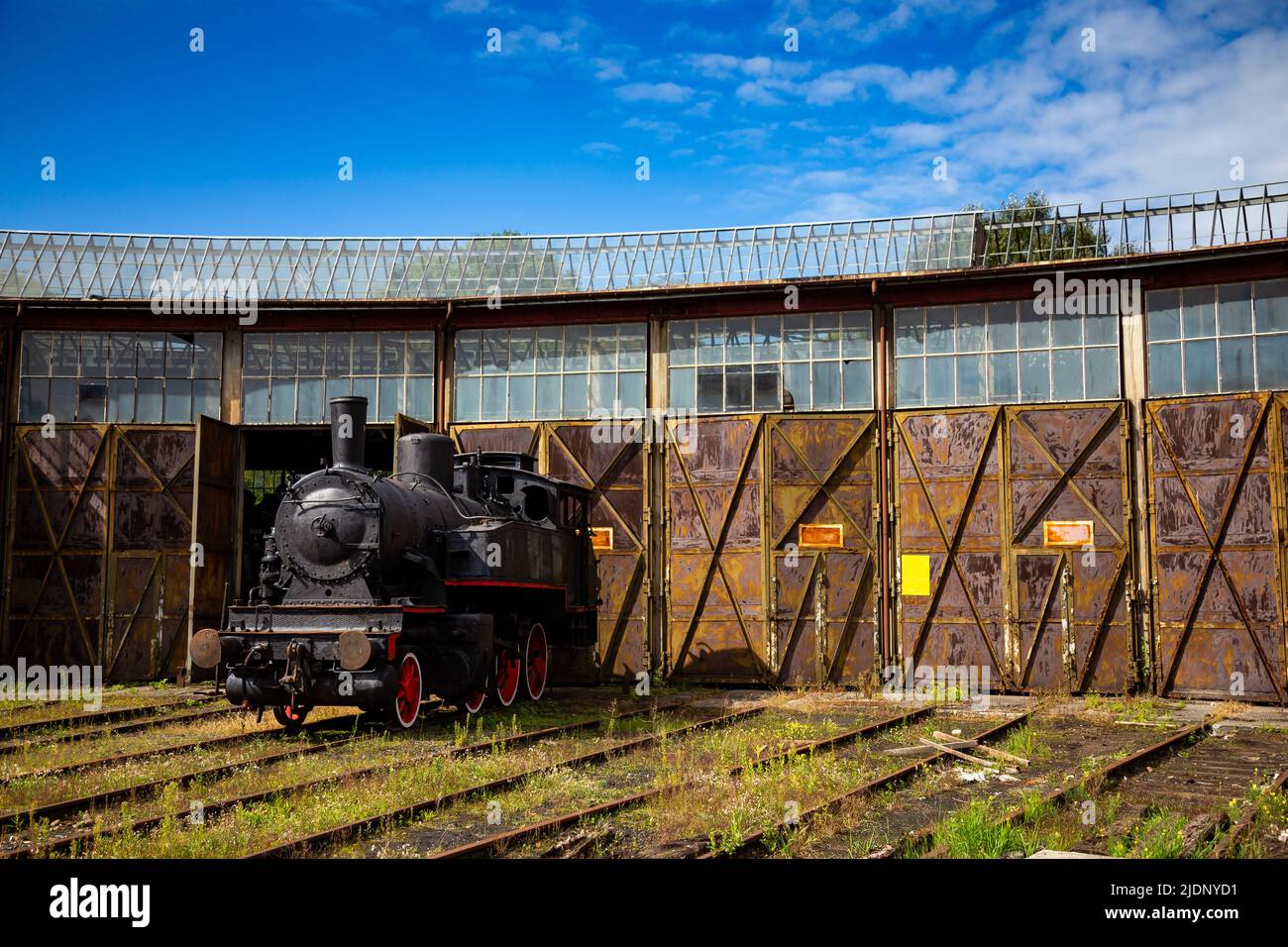A steam locomotive standing outside of historic locomotive shed. The ...
