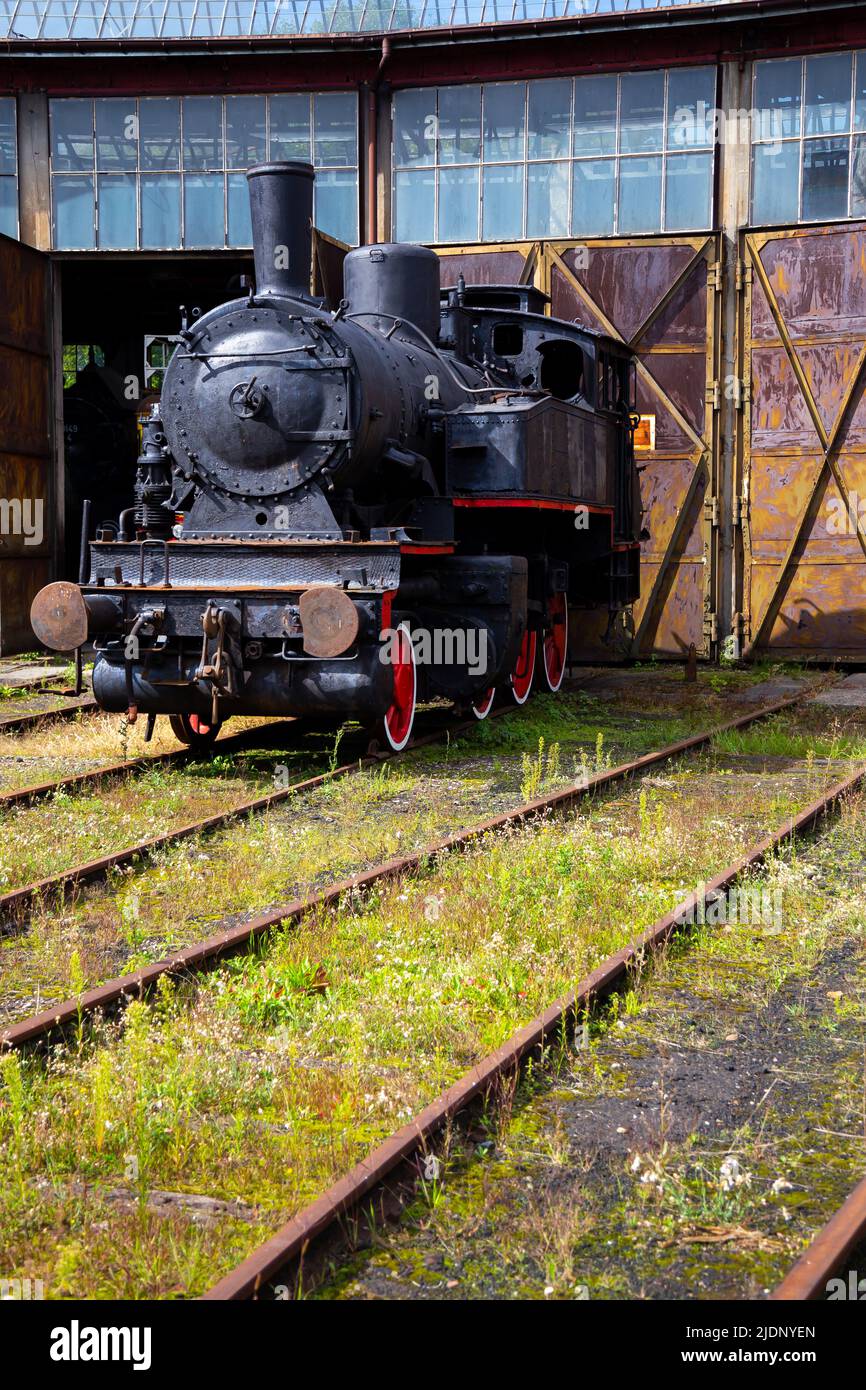 A steam locomotive standing outside of historic locomotive shed. The ...