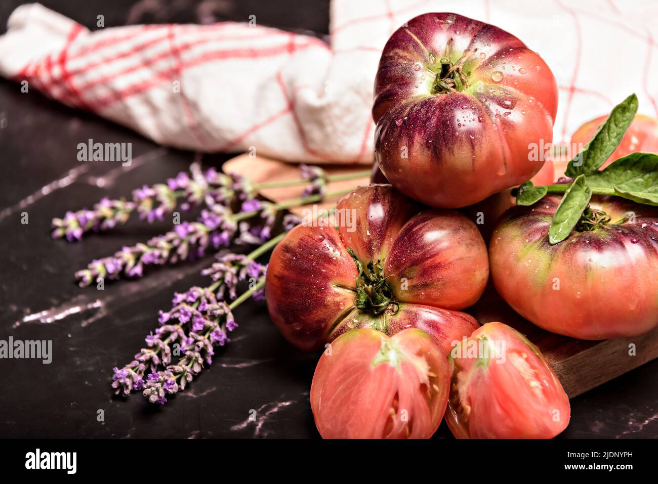 Beautiful fresh tiger tomatoes on dark background Stock Photo - Alamy