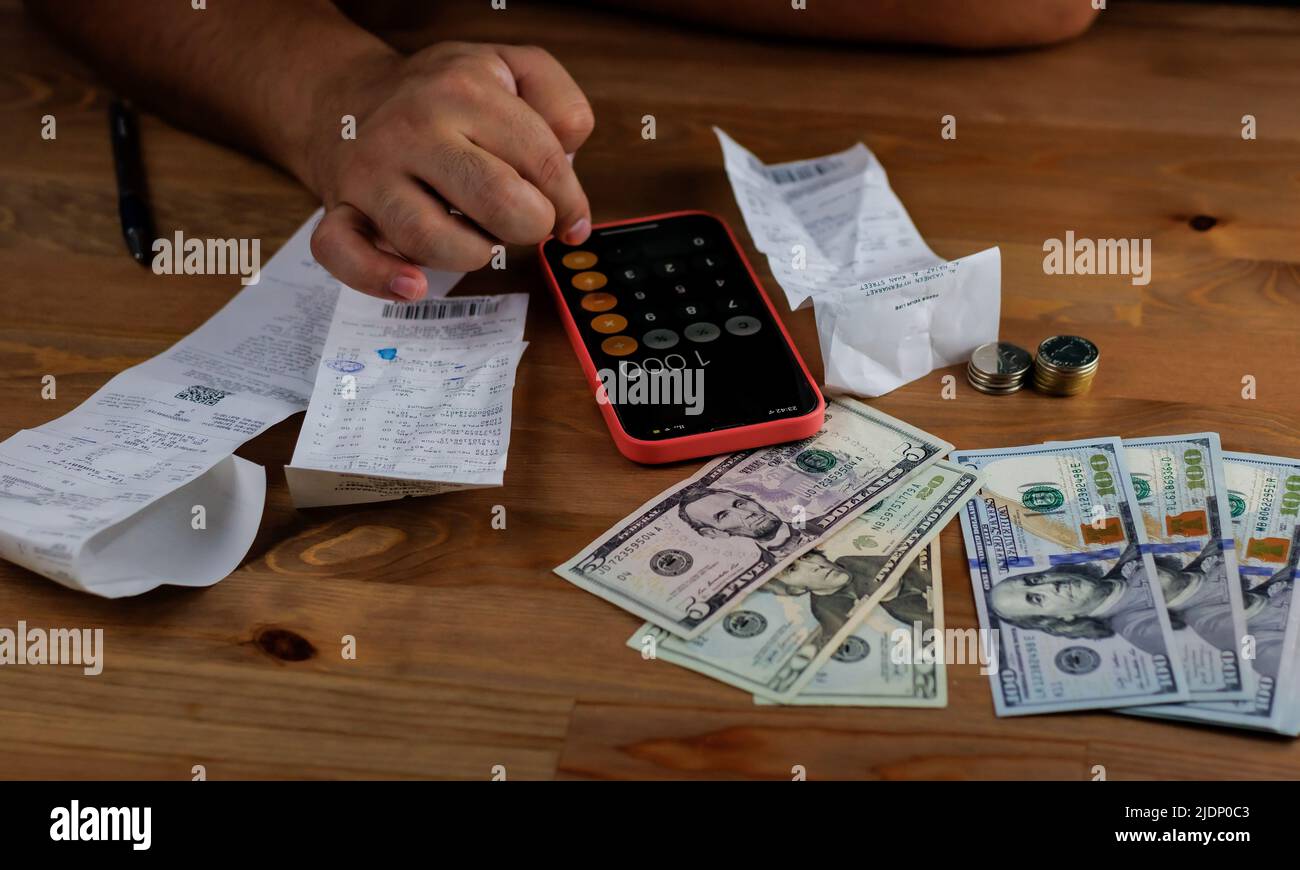 checks on the table with money, a man counts his expenses on a ...