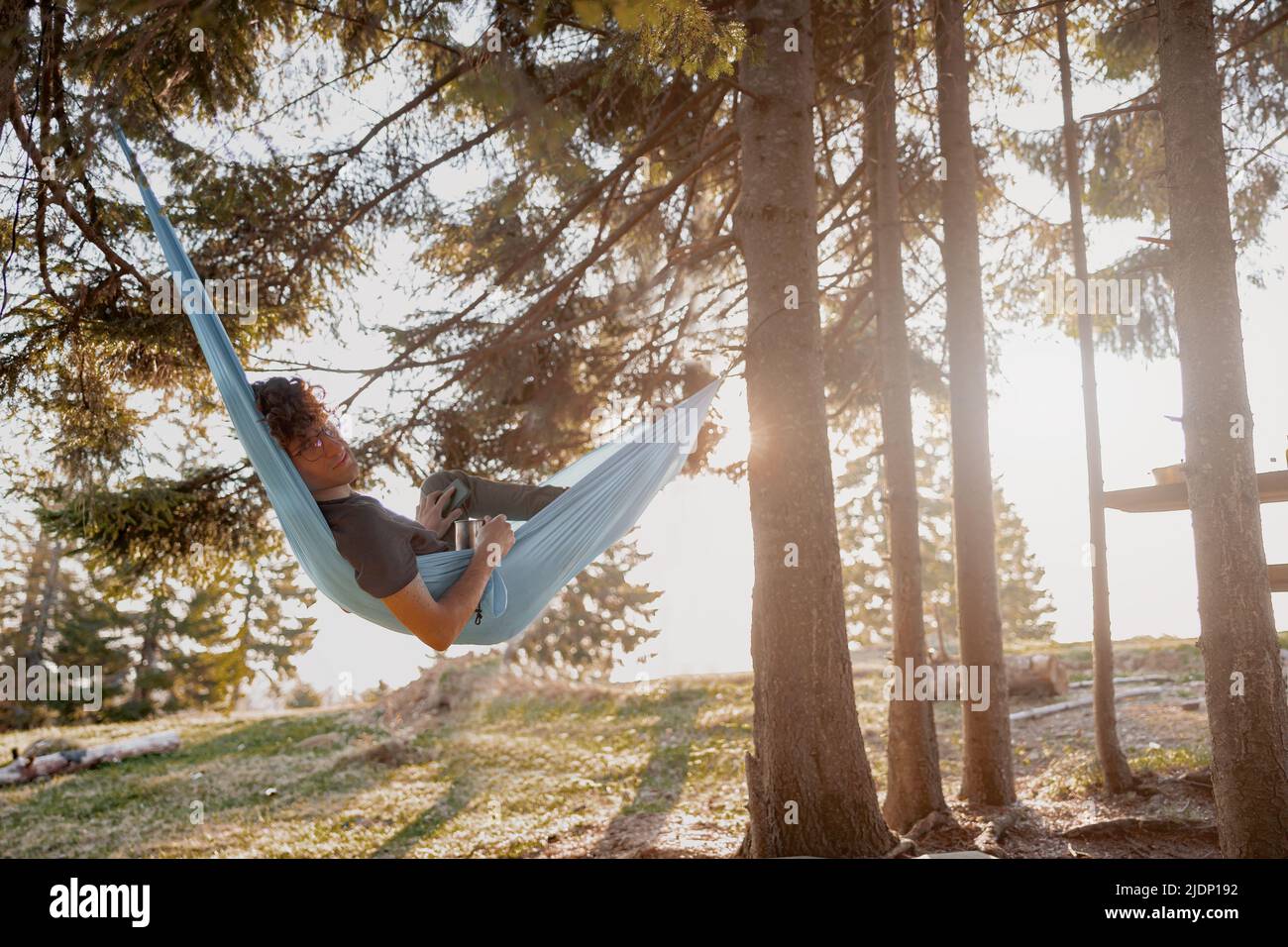 Male sleeping and resting hammock in forest. Beautiful nature. Relaxing ...
