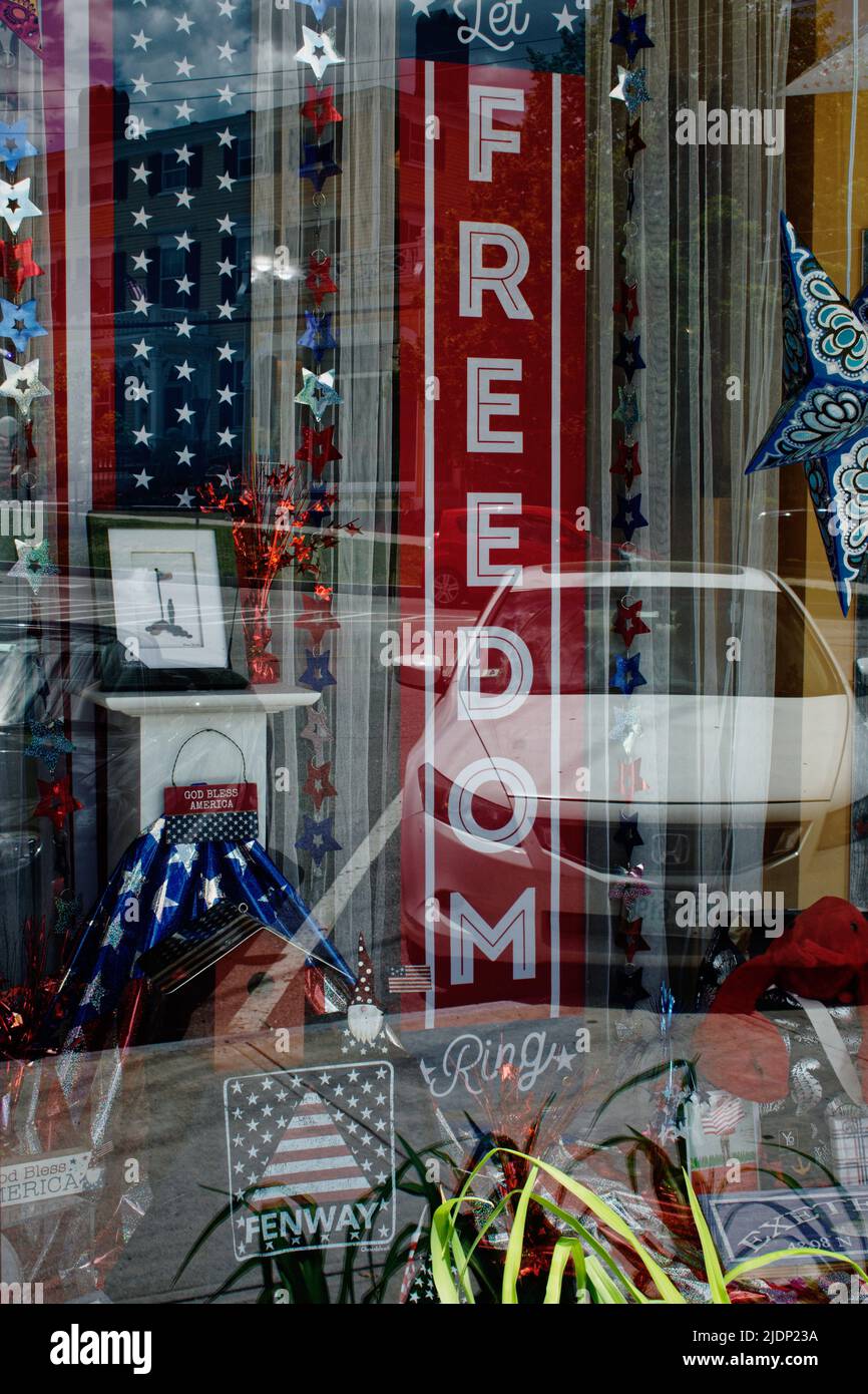 A patriotic storefront window with flags and banners on Water Street in ...