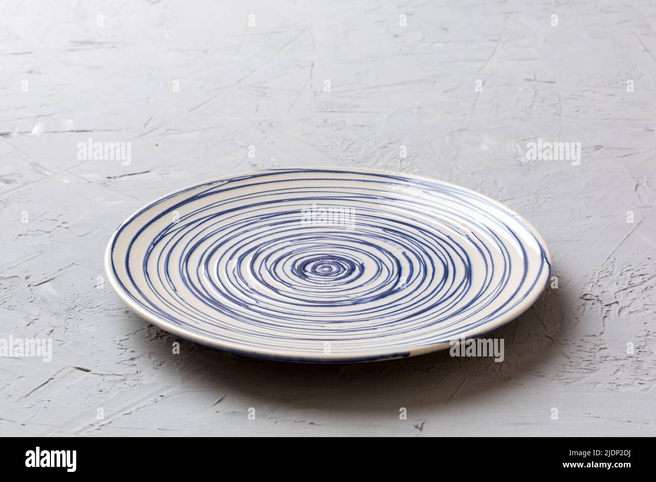 Perspective view of empty colorful plate on cement background. Empty ...