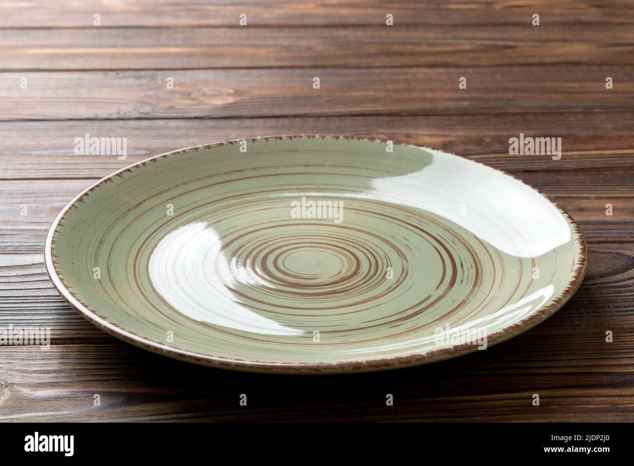 Perspective view of empty green plate on cement background. Empty space ...