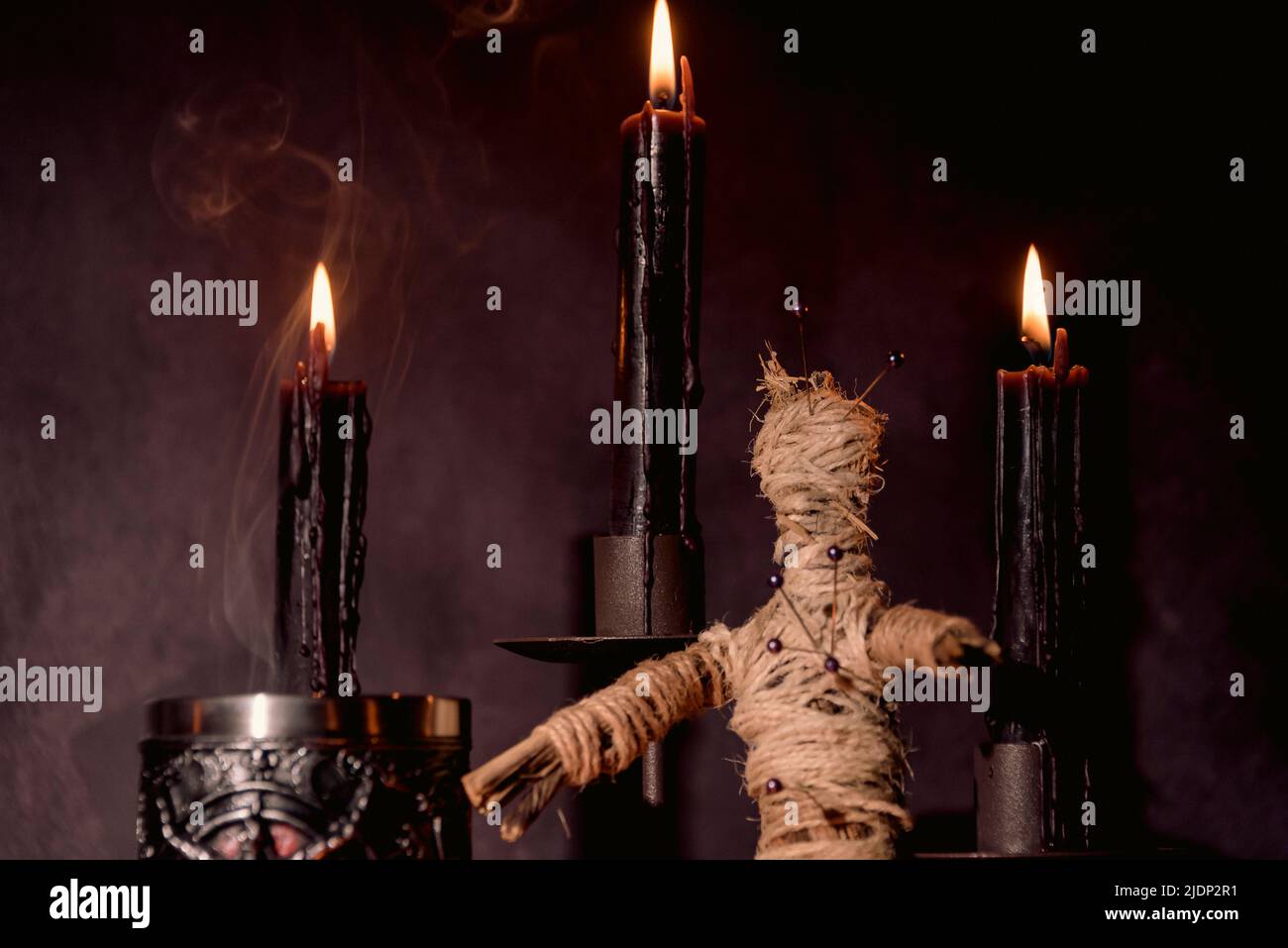Scary voodoo doll with black candles. Mystic background with ritual ...