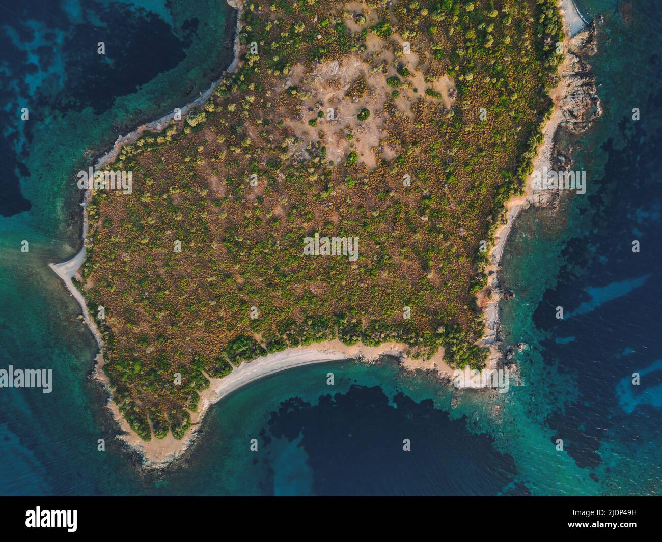 Day drone view above small island with green vegetation and rocky ...