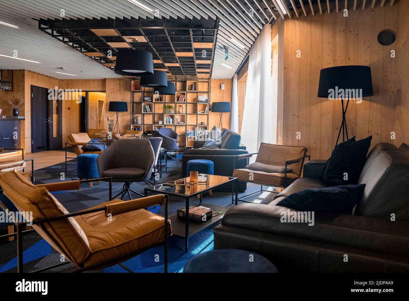 Cozy chairs and sofa arranged in beautiful lounge at luxurious hotel ...
