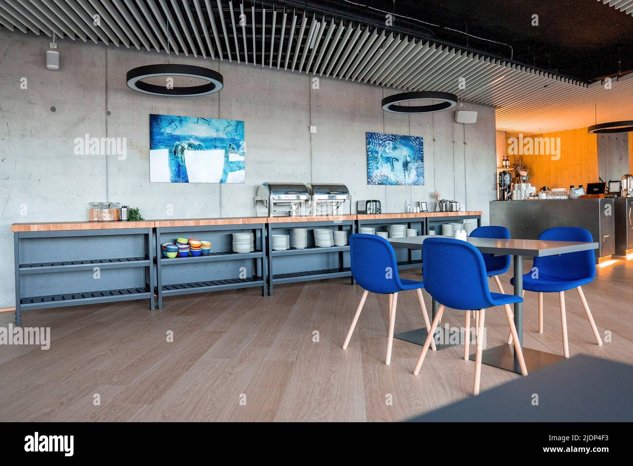 Chairs and tables arranged by counter in restaurant at luxurious resort ...