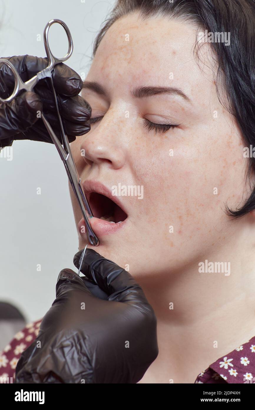 Under tongue piercing hi-res stock photography and images - Alamy
