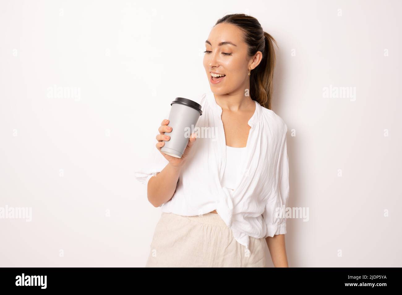 Image of young secretary woman wearing white casual shirt drinking ...