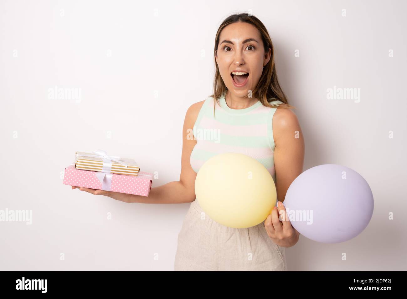 Close-up portrait of happy exited pretty brunette woman holding gift ...