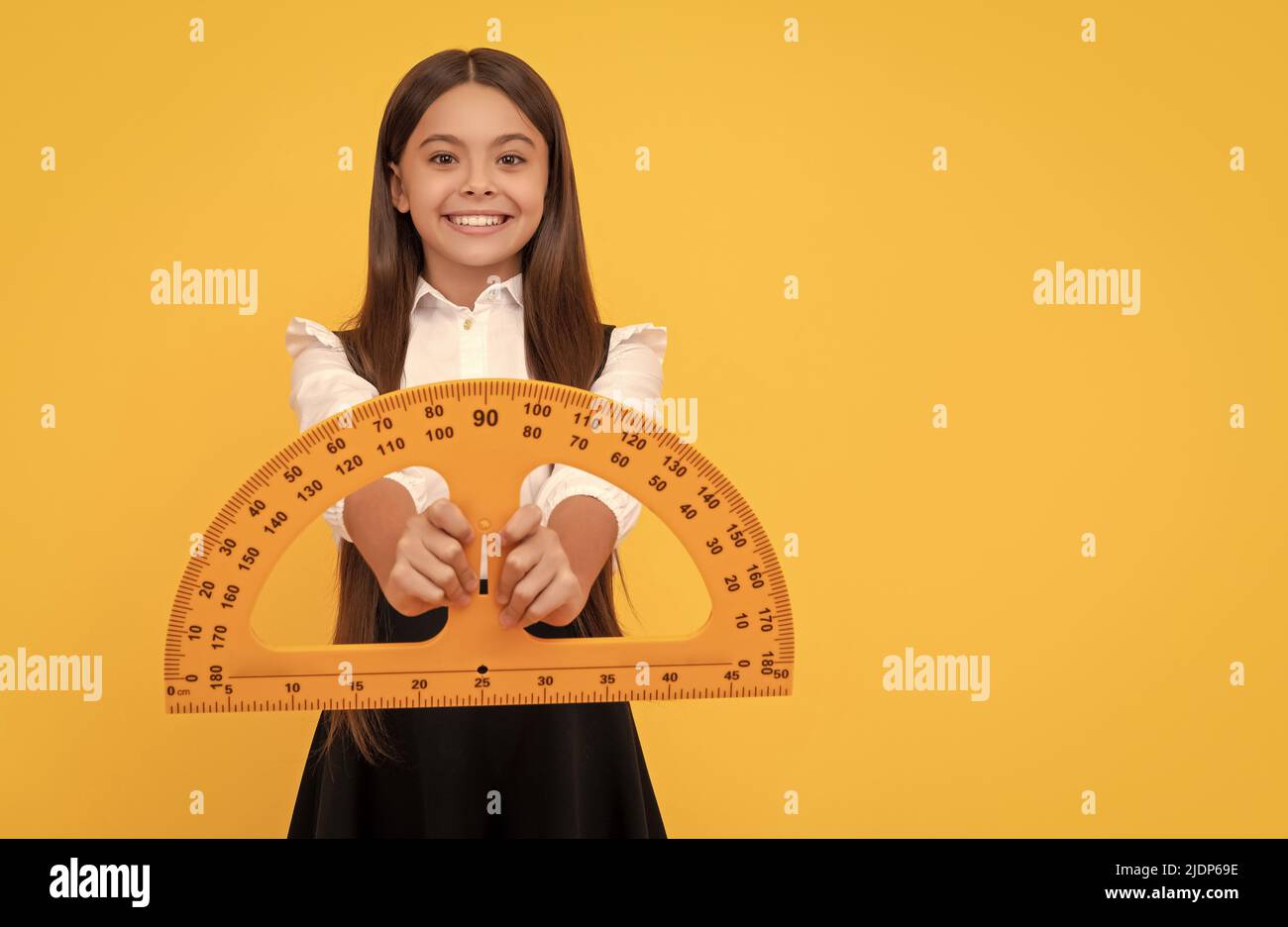 cheerful kid in school uniform hold mathematics protractor for ...