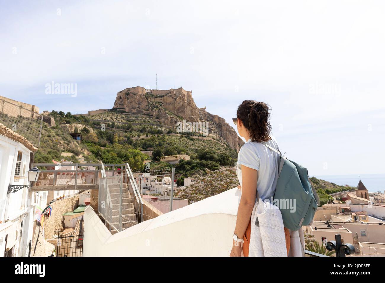 Back view of young woman traveler with backpack, in Alicante, Spain Stock Photo - Alamy