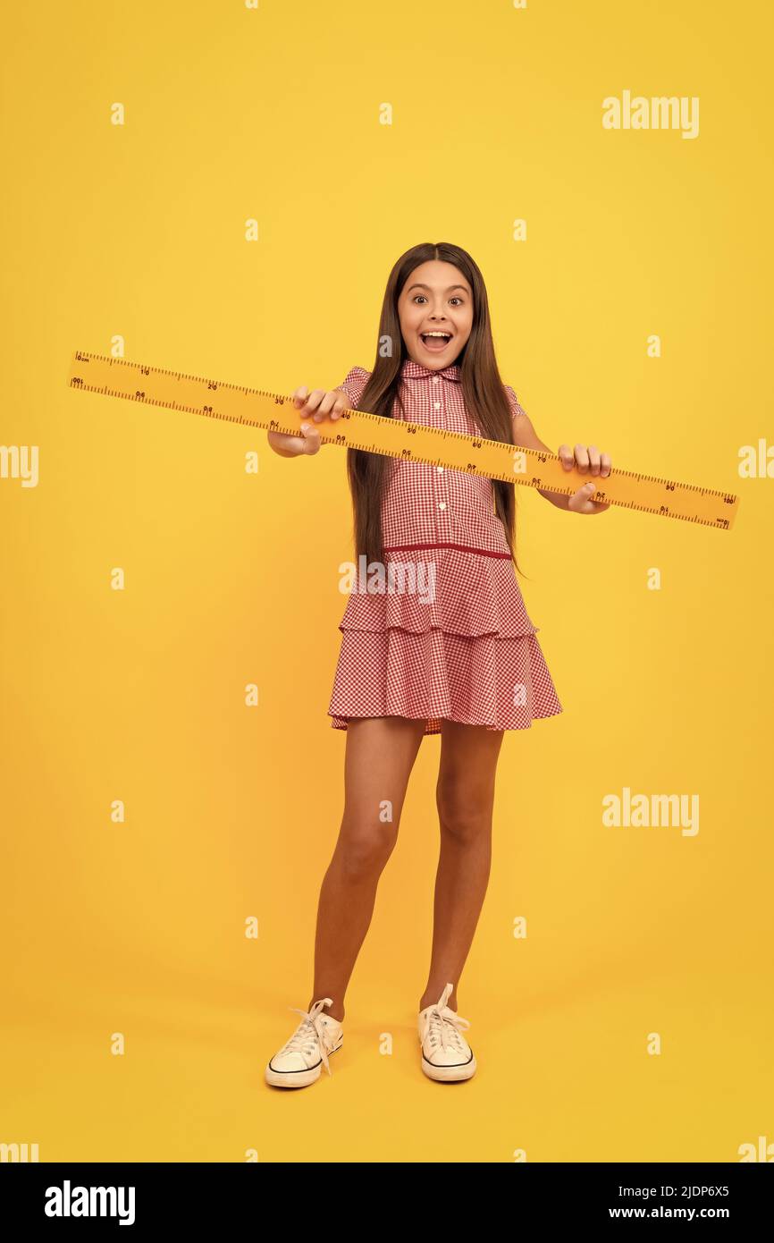 amazed teen girl hold ruler. back to school. algebra and geometry. kid ...