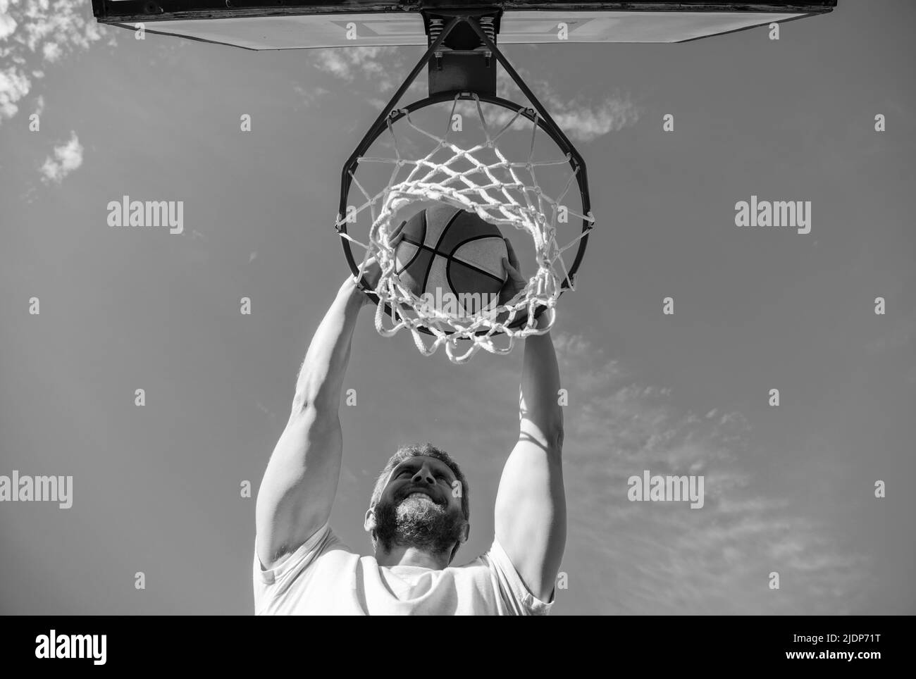 cheerful man player throw basketball ball through basket, motivation ...