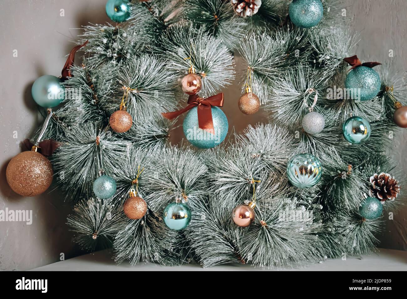 Christmas light blue wreath on a concrete wall background Stock Photo ...