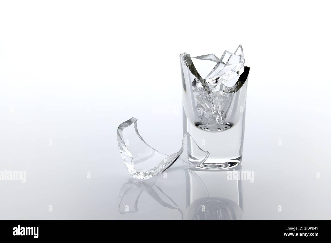 Shards of broken glass goblet and reflection on white background Stock ...
