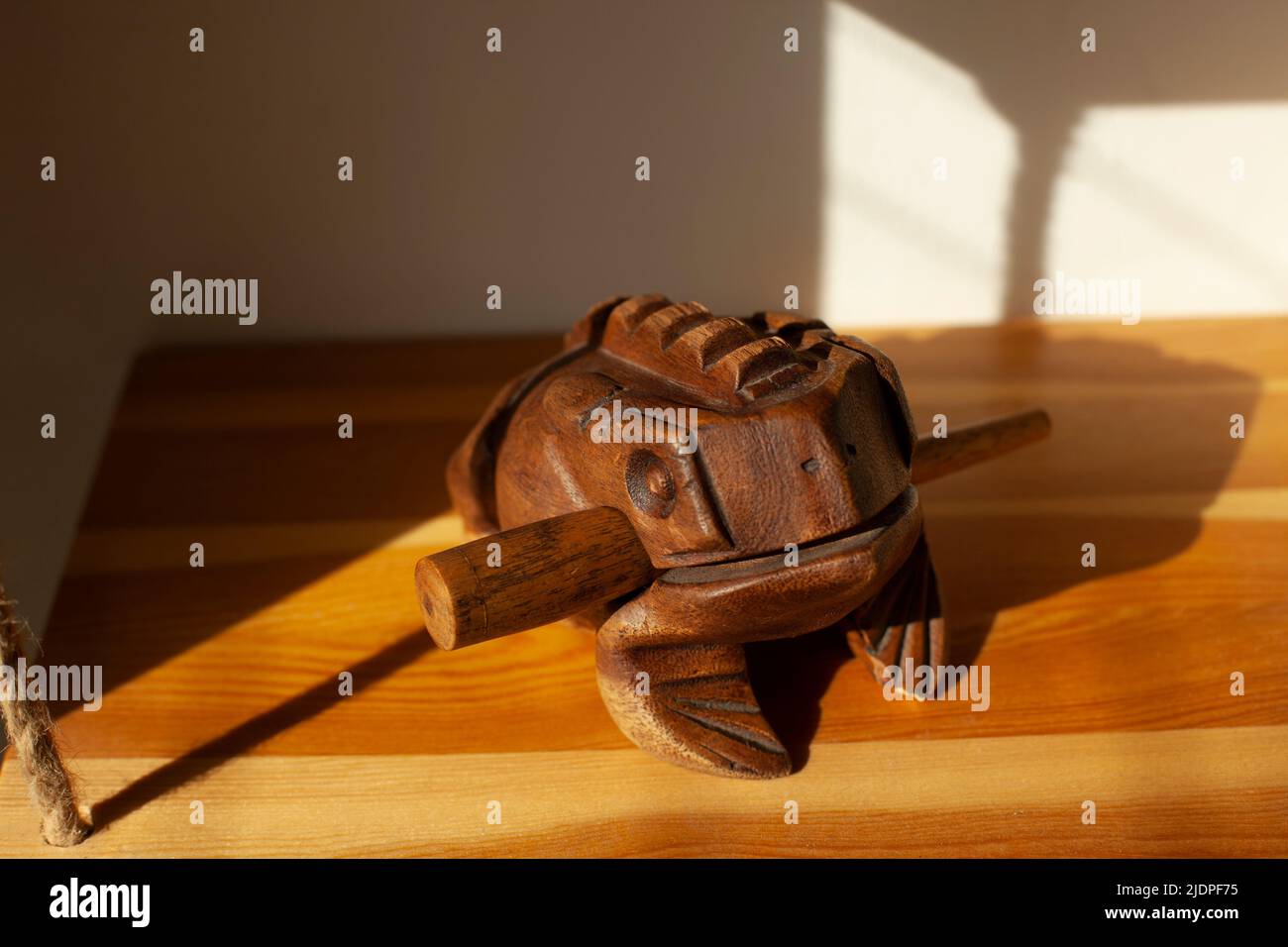 Wooden frog. Musical instrument made of wood. Stick and frog with teeth ...