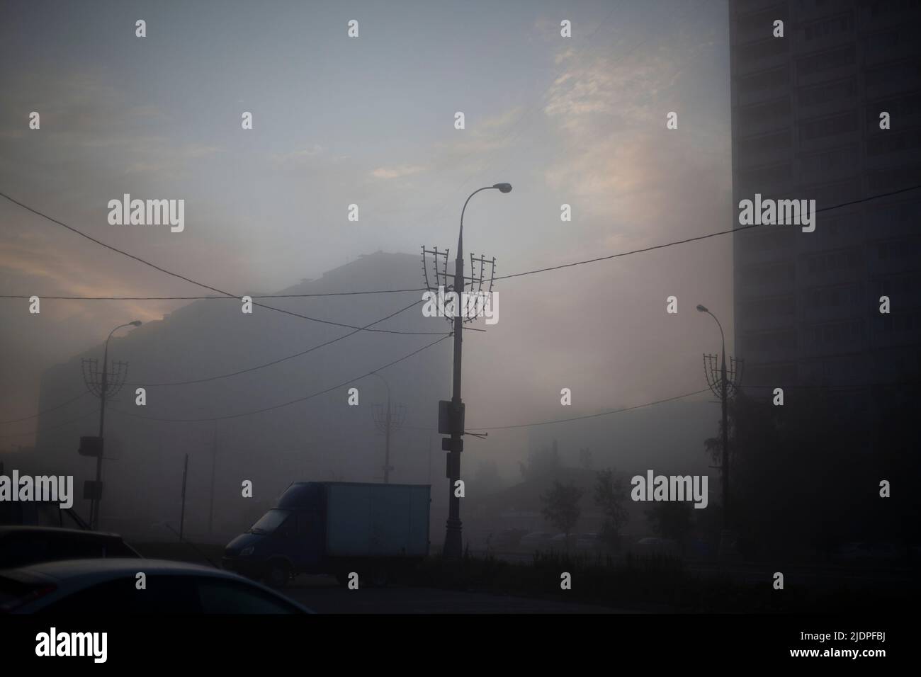 Building is in fog. City in morning. Tall building in morning haze ...