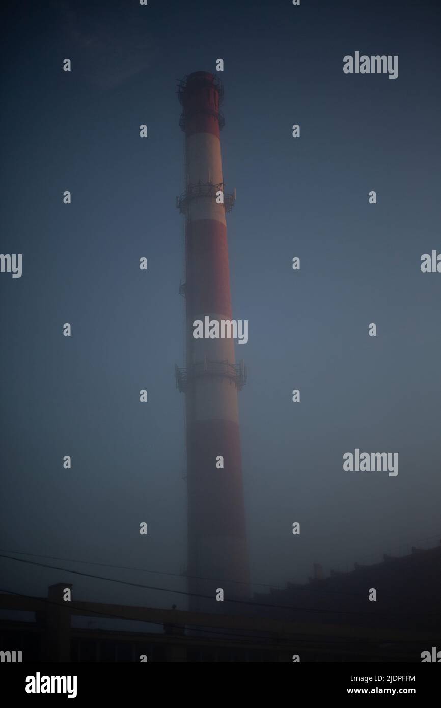 Pipe of plant is in fog. View of industrial area in morning. Haze in ...