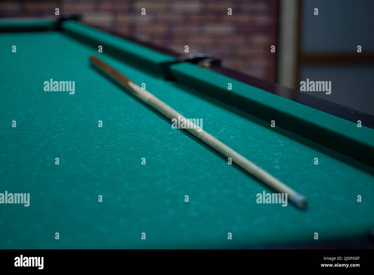 Cue on pool table. Relaxation room is in detail. Sports equipment ...