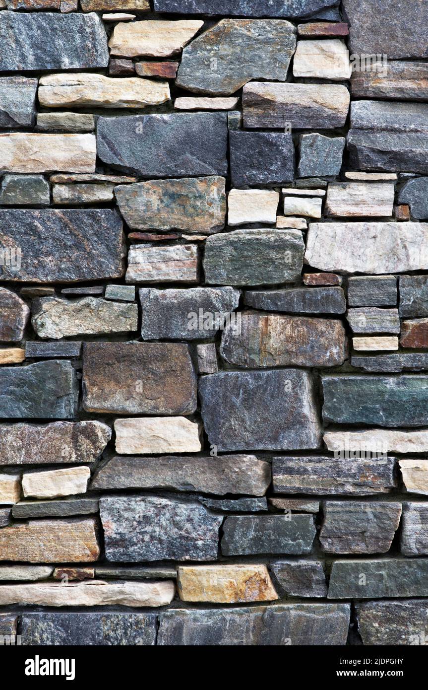 Closeup vertical image of a stone wall Stock Photo - Alamy