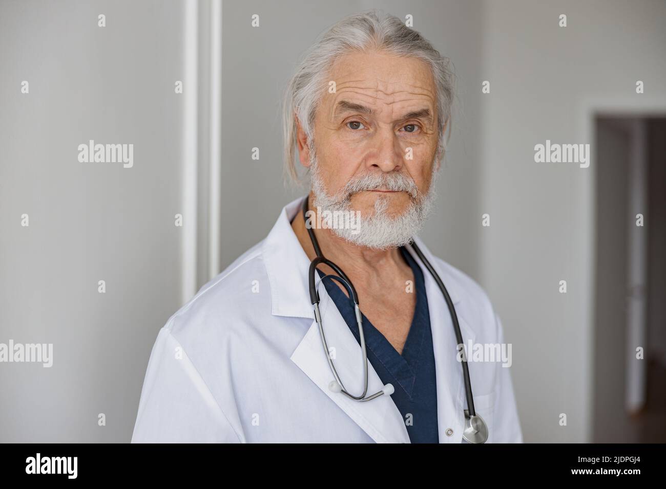 Portrait of professional doctor in uniform standing in medicine clinic ...
