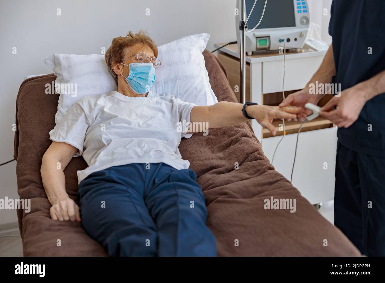 Nurse checking with fingertip pulse oximeter oxygen saturation of ...