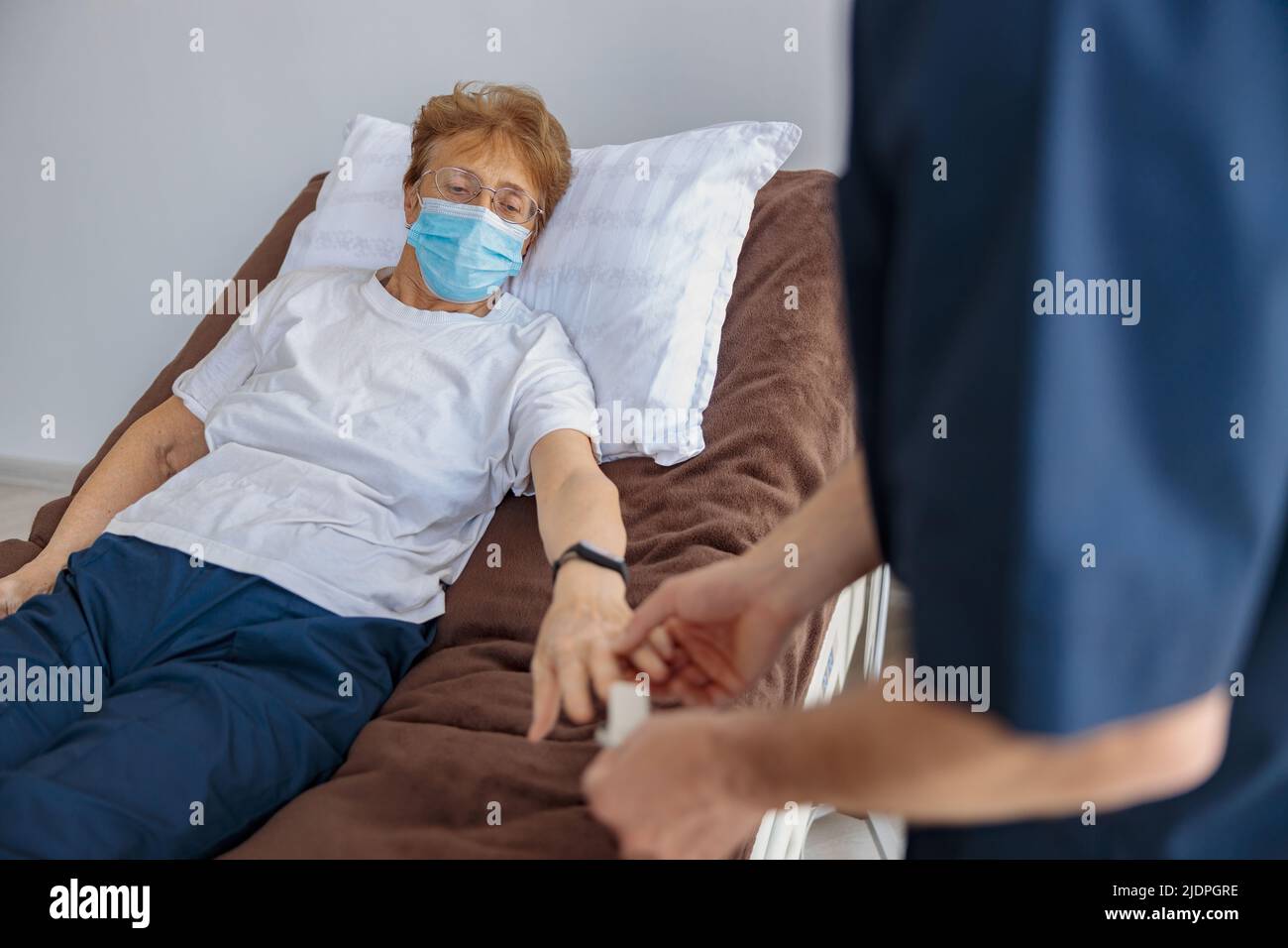 Nurse checking with fingertip pulse oximeter oxygen saturation of ...