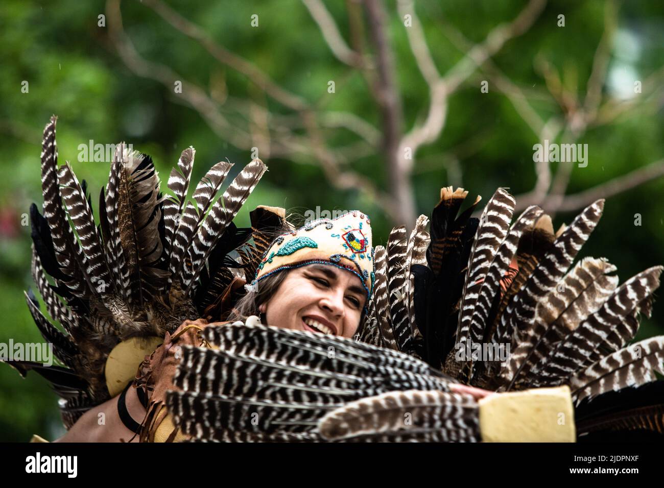 An Indigenous dancer in traditional dress takes part during the concert ...