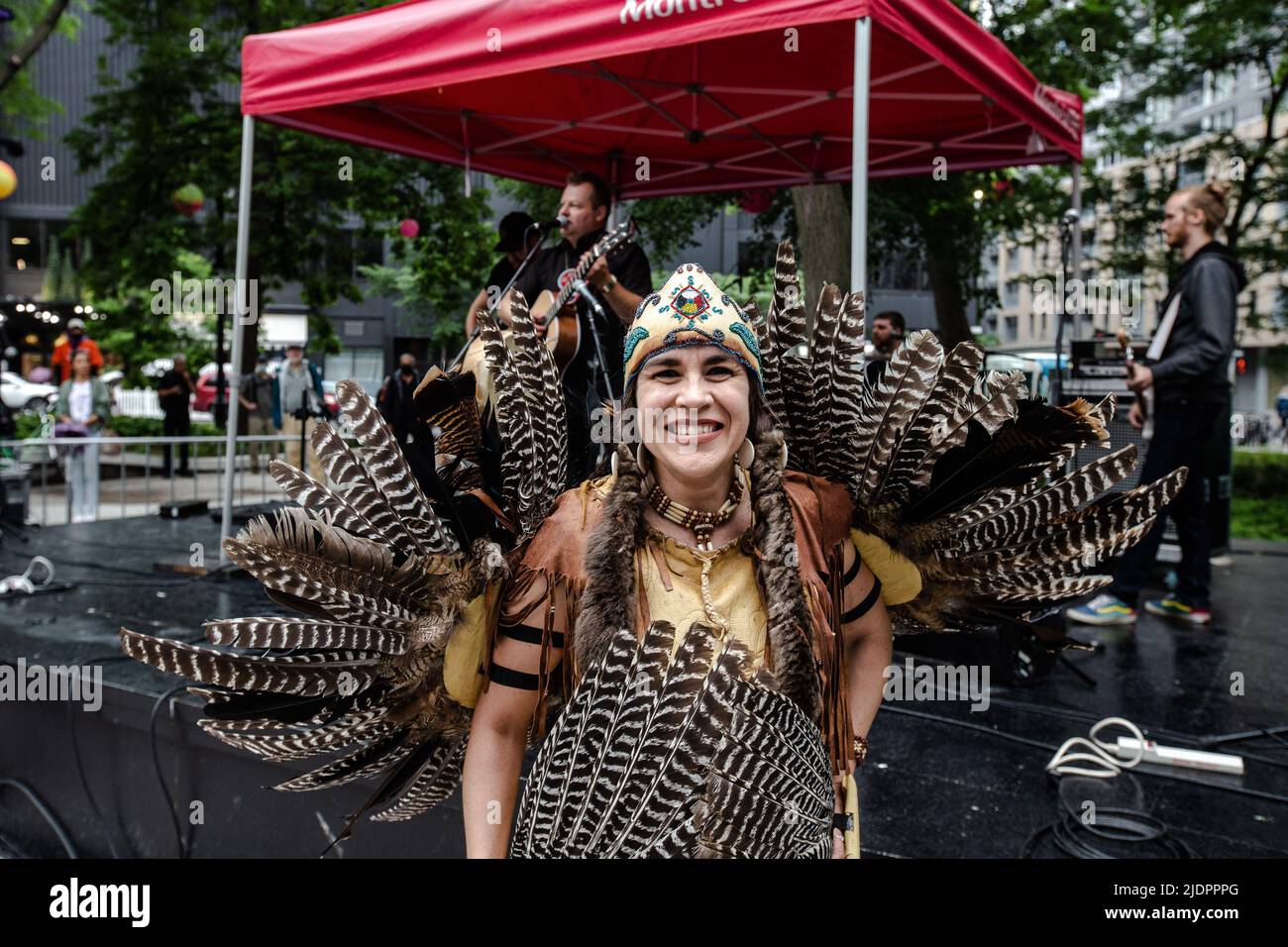 An Indigenous dancer in traditional dress takes part during the concert ...