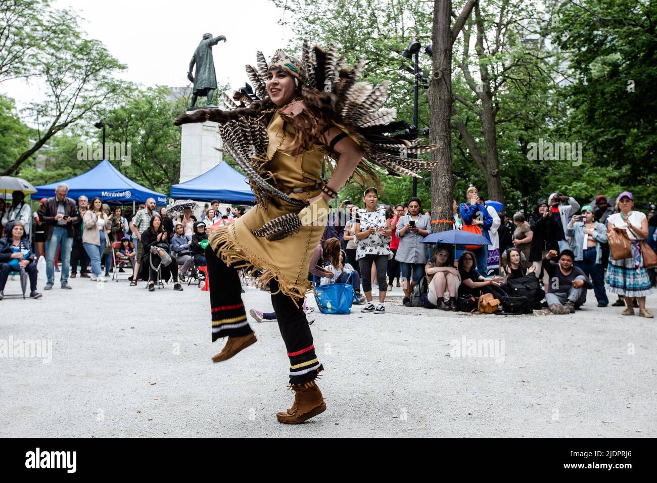An Indigenous dancer in traditional dress takes part during the concert ...