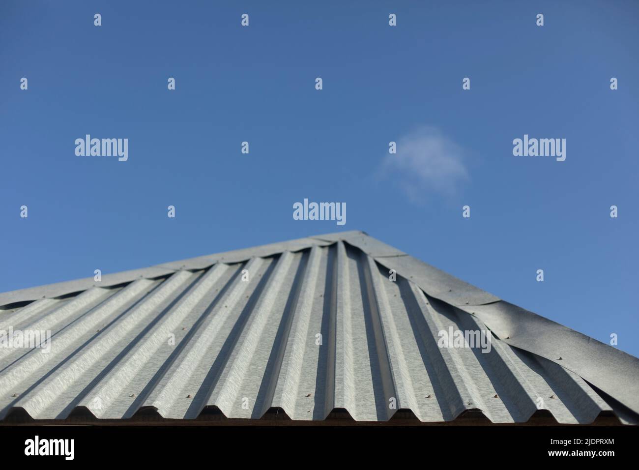Stainless steel roof. Steel roof of house. Small building. Details of ...