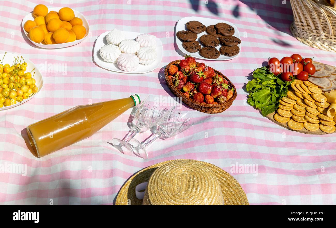 Fruits, sweets, juice on a picnic blanket in the summer garden Stock ...