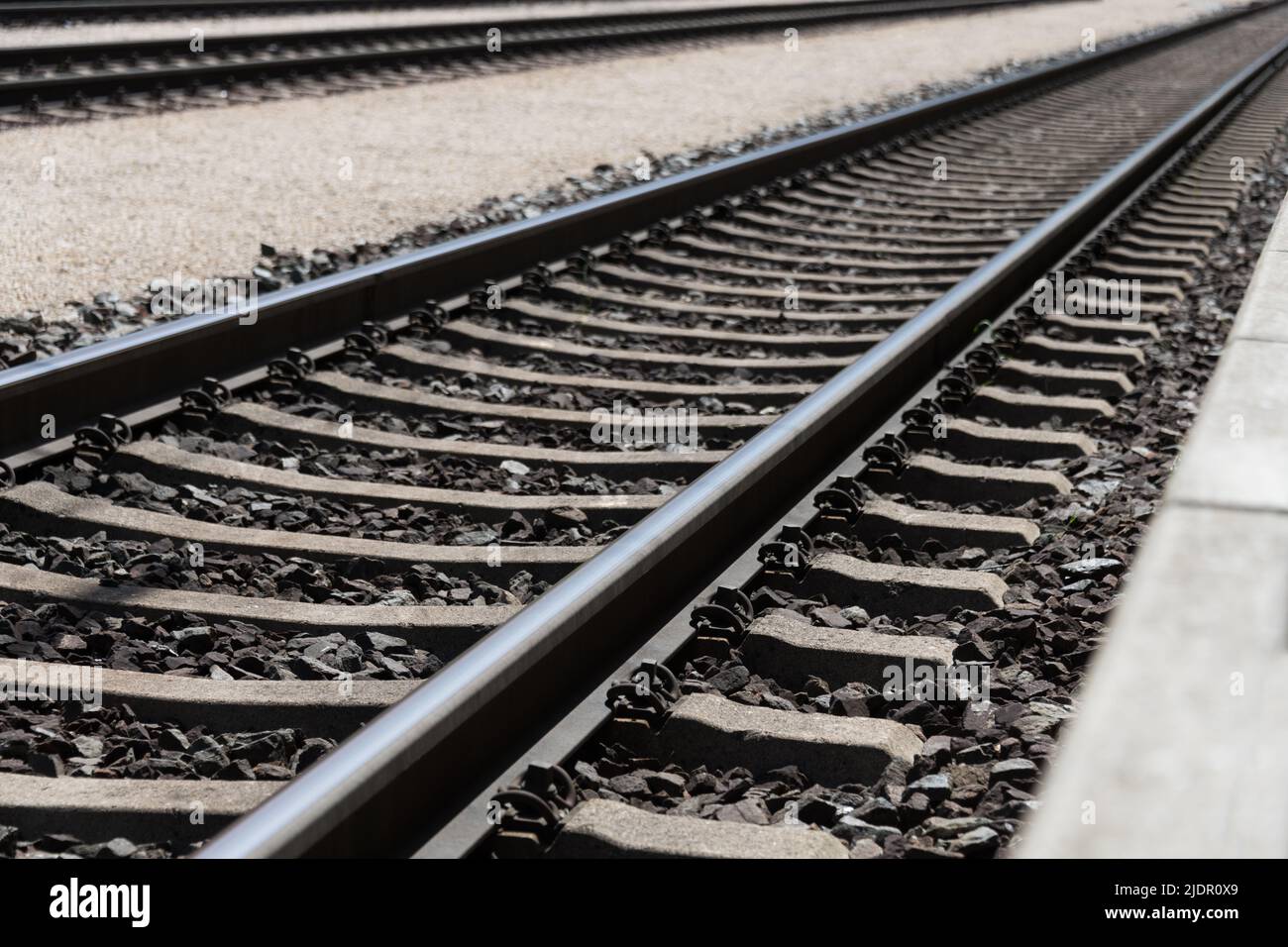 Photo of railroad tracks running diagonally through the picture with ...