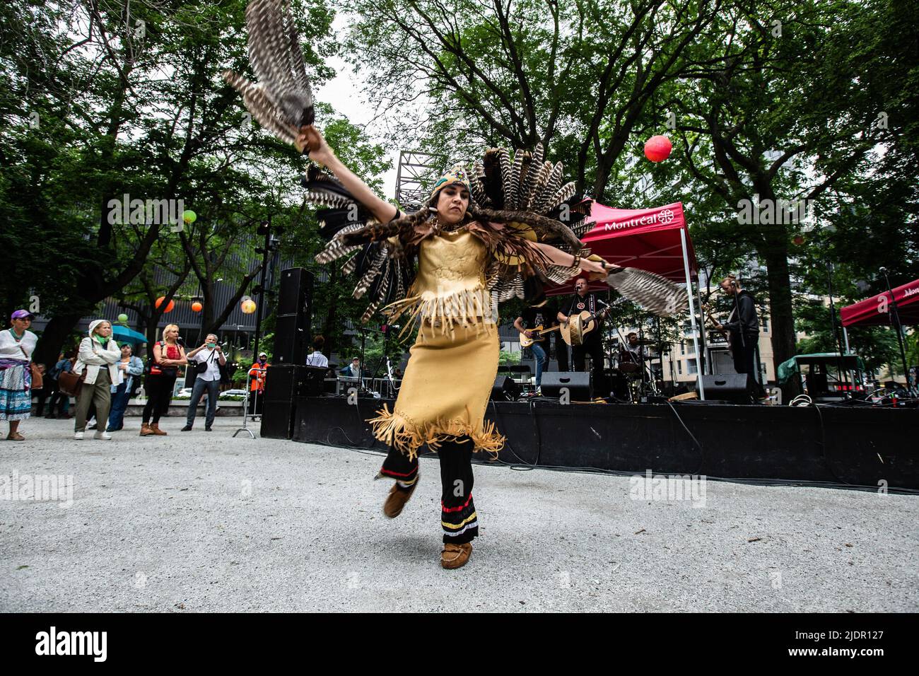 An Indigenous dancer shows a traditional dance in the concert to ...