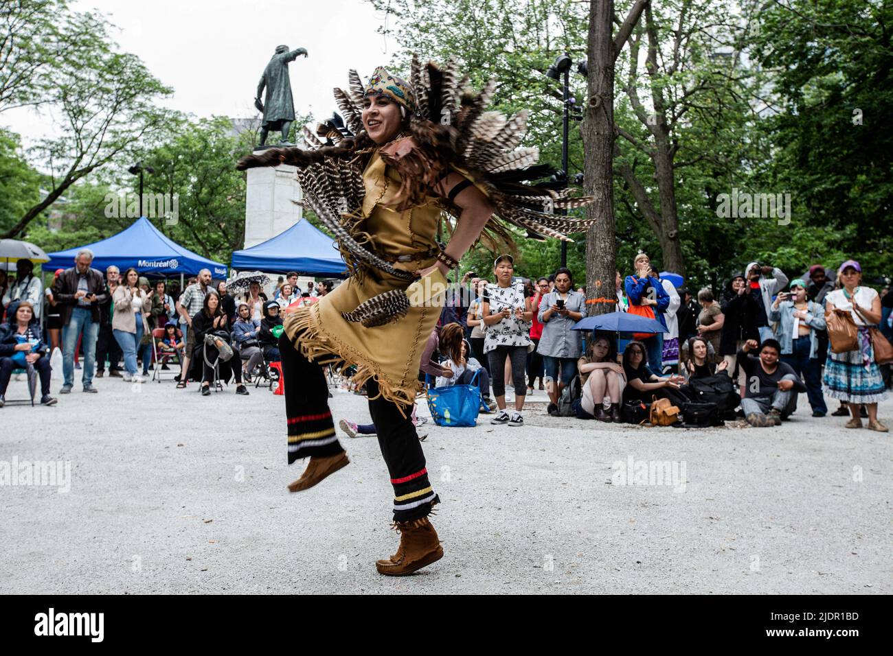 An Indigenous dancer shows a traditional dance in the concert to ...