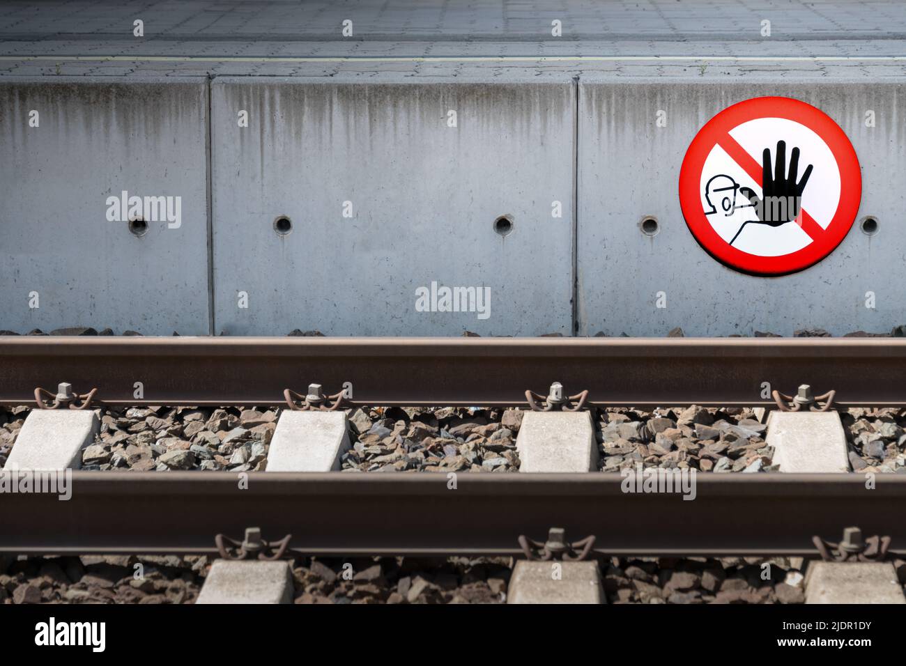 Side of a platform behind a railroad track with clearly visible Stop ...