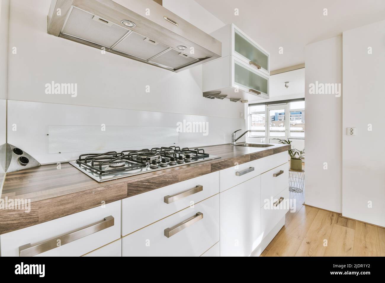 Interior of a modern open plan kitchen with built-in appliances and ...