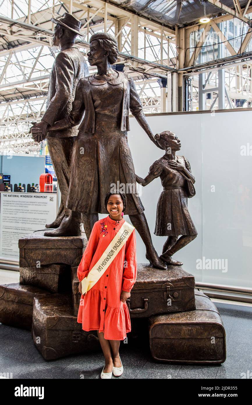 London, UK. 22nd June, 2022. A school girl stands in front of monument ...