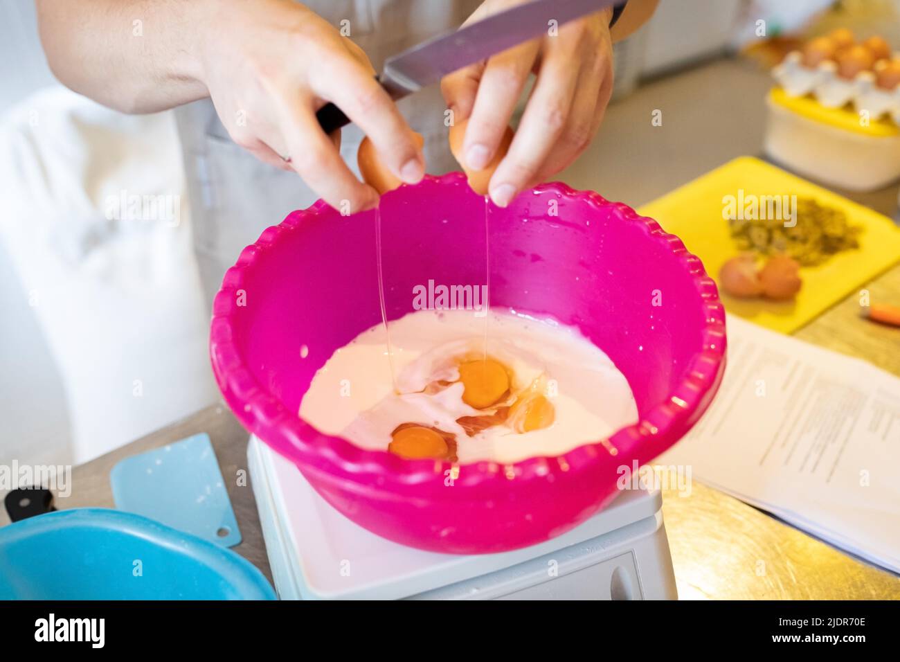 The process of making artisan bread. Adding eggs to milk for muffin dough. Front view Stock ...
