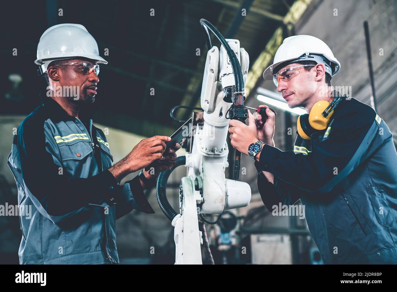 Factory Workers Working With Adept Robotic Arm In A Workshop Industry