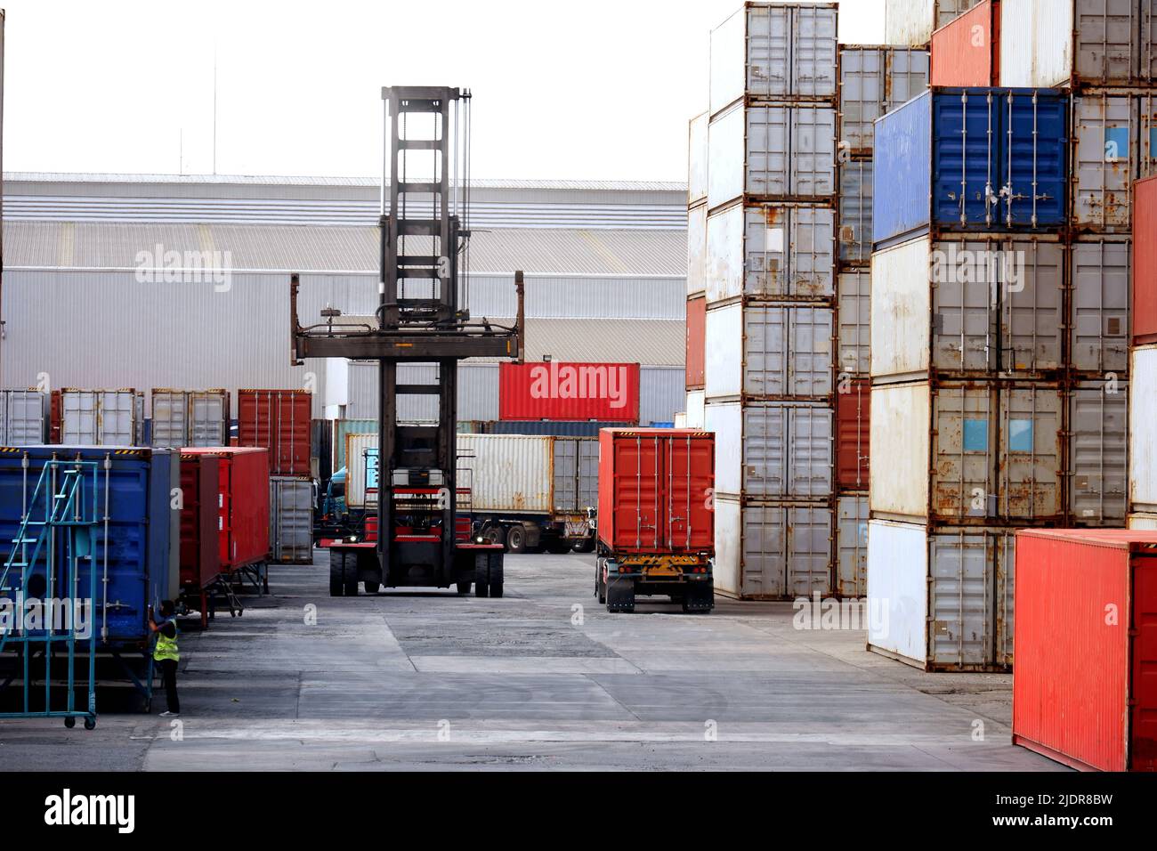 Forklift truck handling cargo container boxes in logistic delivery yard ...