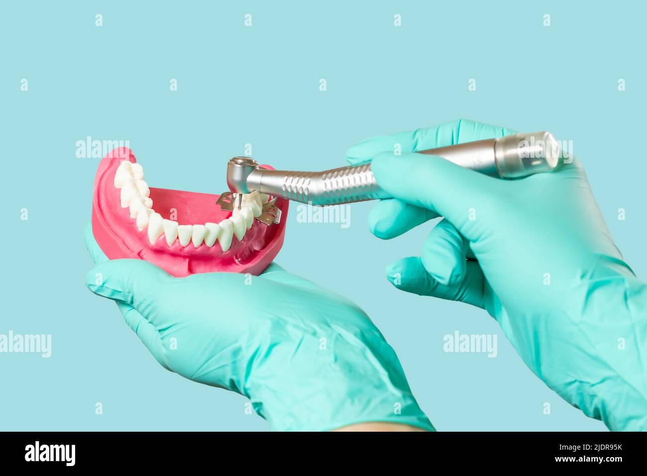 Head of high-speed dental handpiece with bur and a layout of the human ...