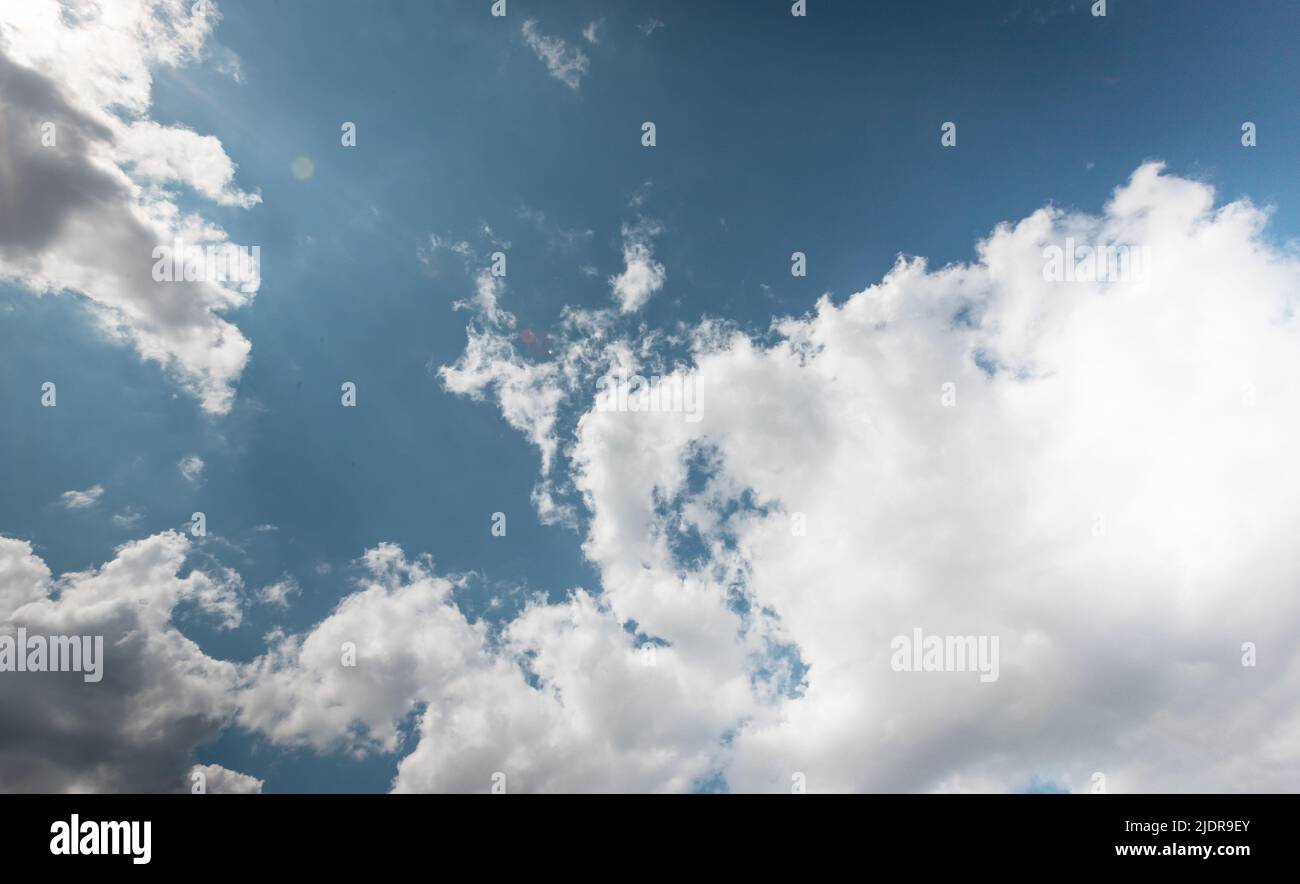 Sky background. White clouds with sunshine behind . Cloudy day ...