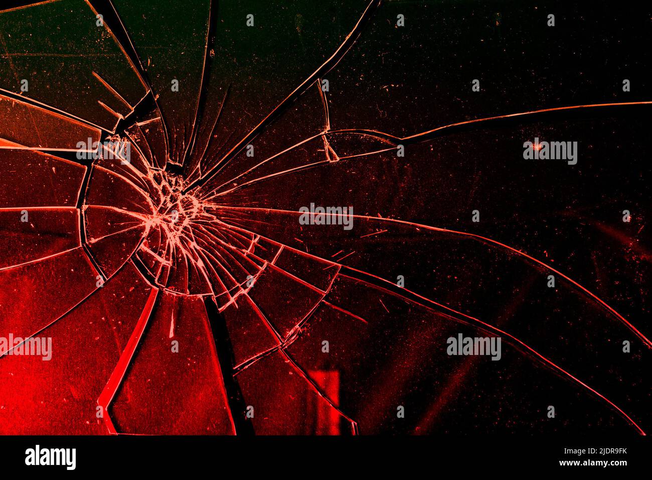 Сracked glass close-up on red background. Texture of broken glass Stock ...