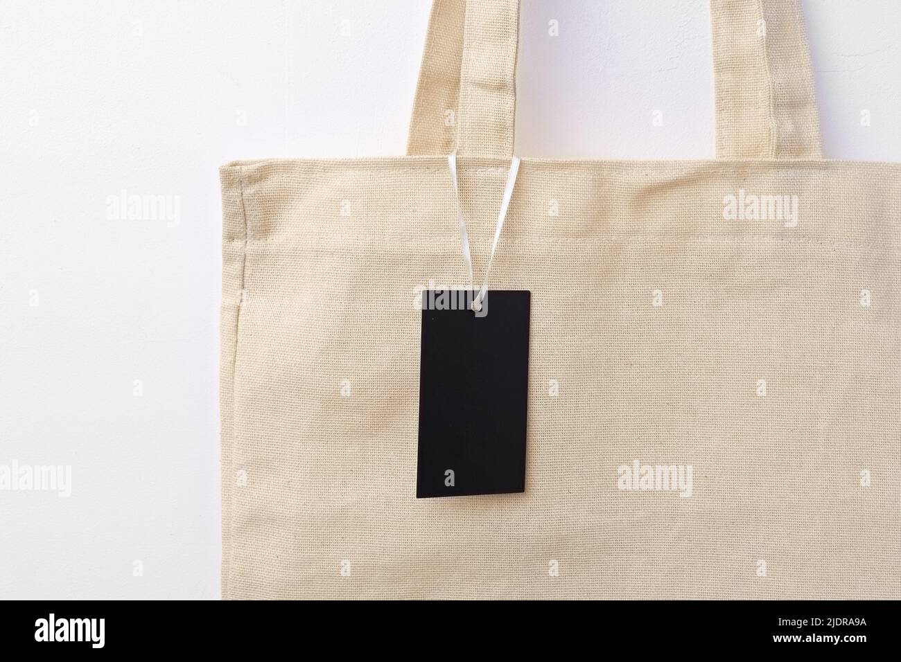 Eco bag for shopping with blank tag on white background Stock Photo - Alamy