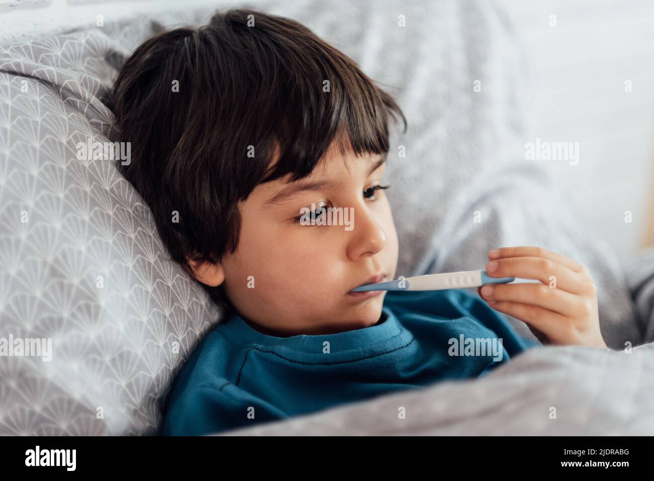 Child flu sick, boy with medical thermometer in mouth, health illness. Kid with cold rhinitis ...