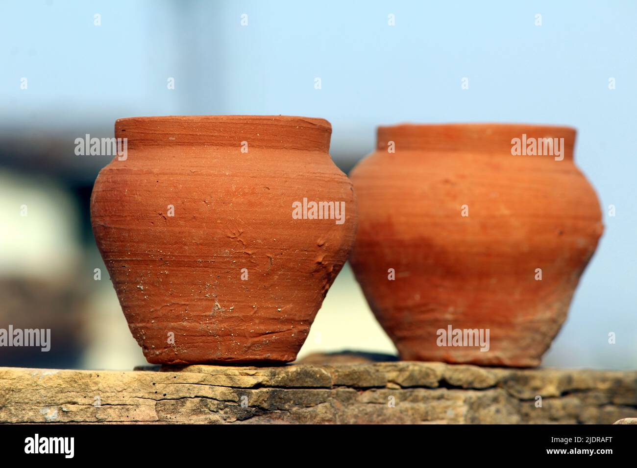red color clay pot put on a stone Stock Photo - Alamy