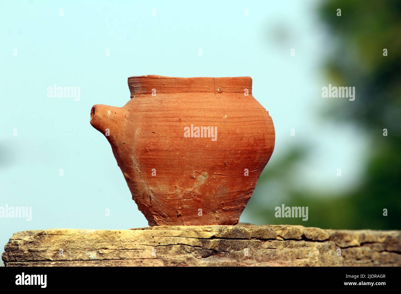 red color clay pot put on a stone Stock Photo - Alamy